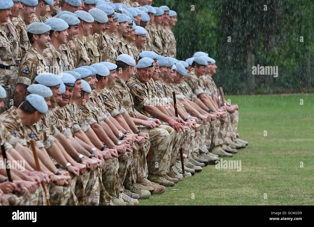 The Prince of Wales, (front row centre) is caught in a torrential down ...