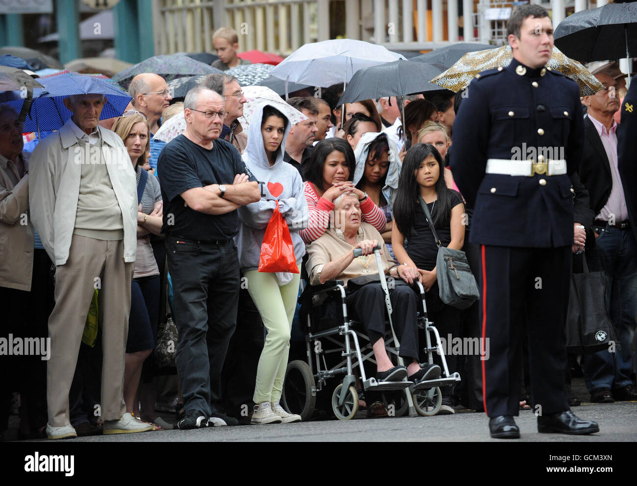 Mourners gather in the streets ahead of the funeral of Marine David ...
