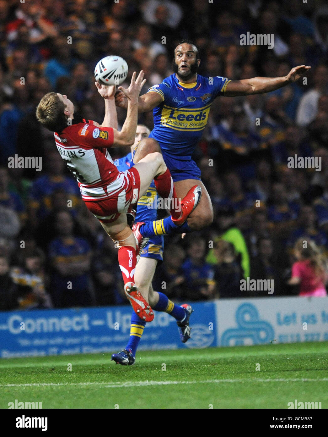 Wigan's Sam Tomkins (left) and Leeds Rhinos' Jamie Jones-Buchanen jump ...