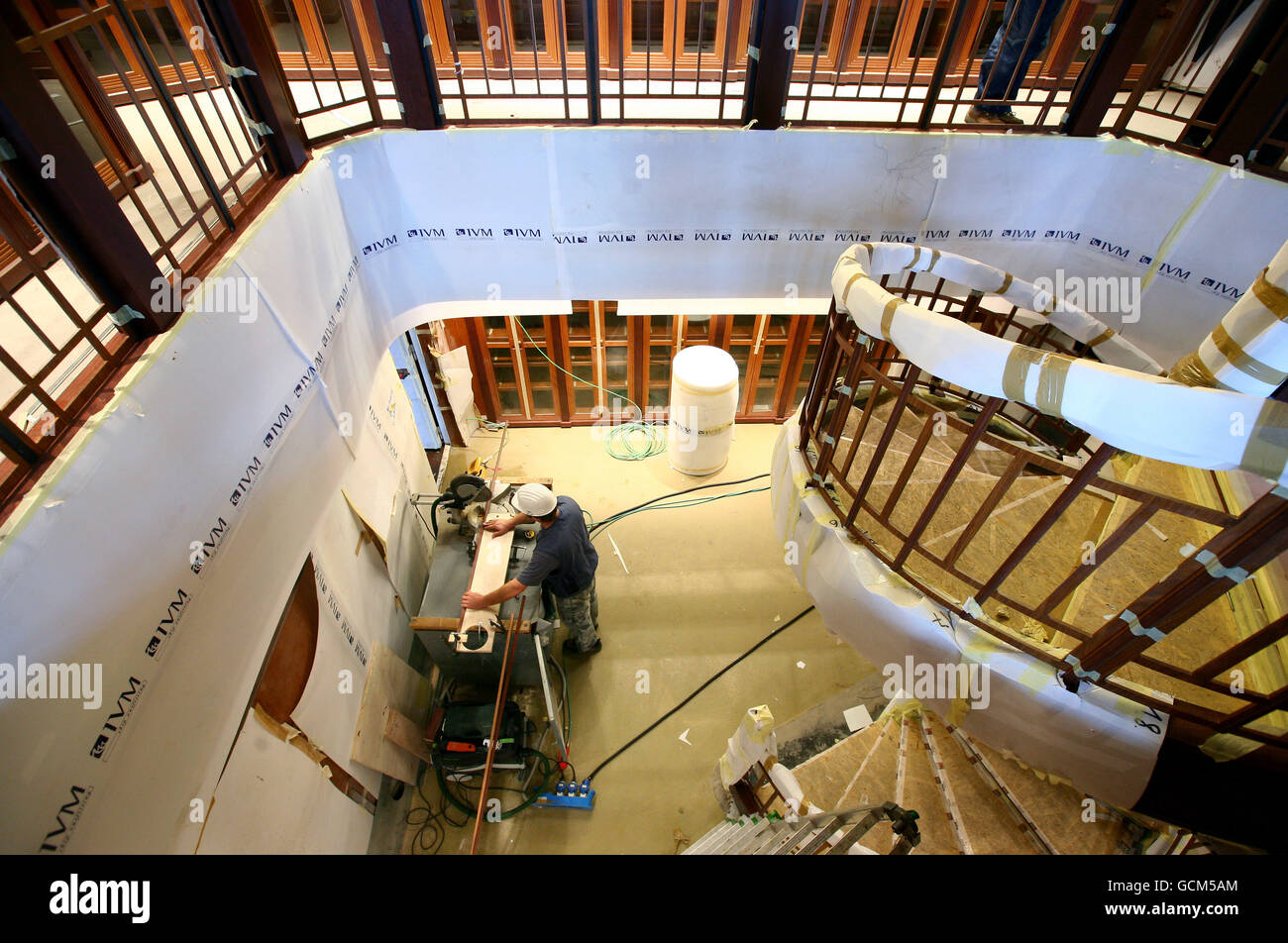 An engineer works to complete the library onboard Cunard's new cruise ...