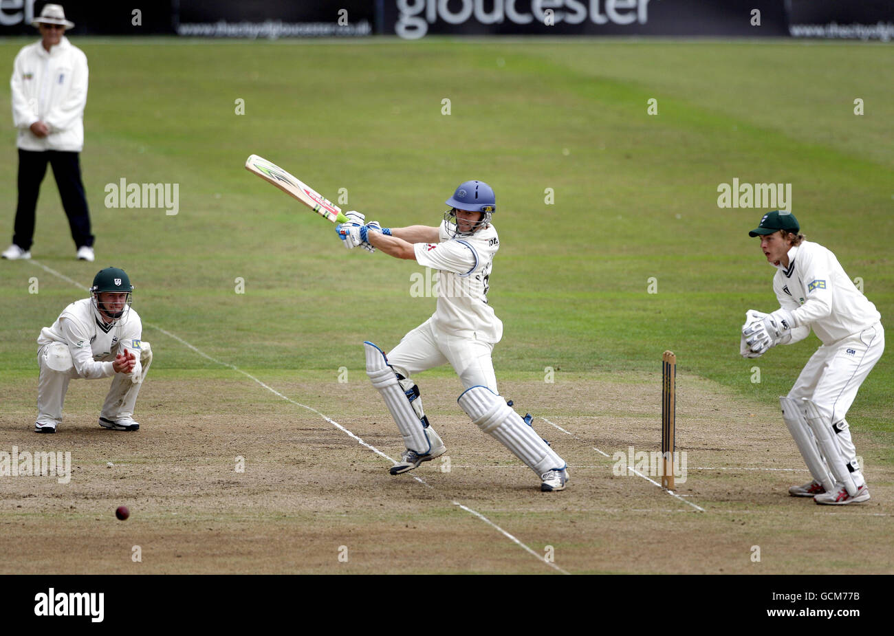 Gloucestershire's Will Porterfield hits the ball for four to bring up ...