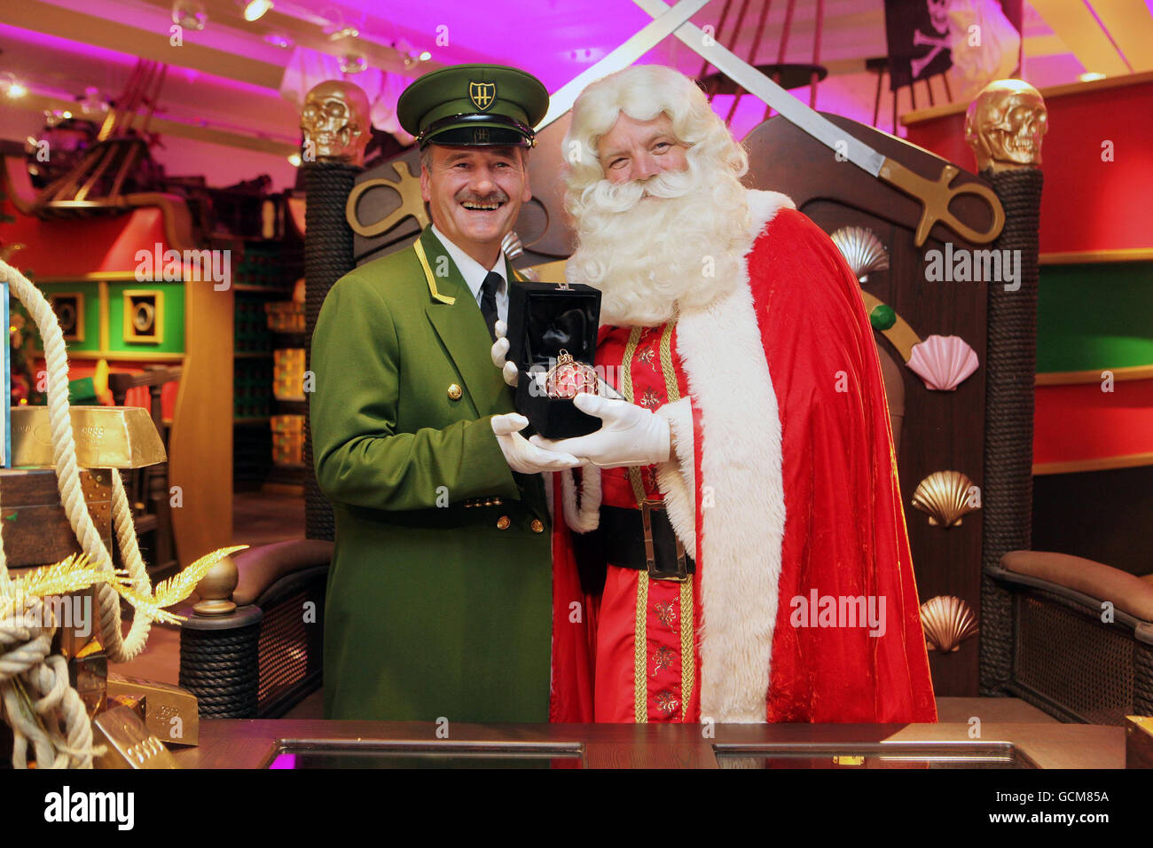 Father Christmas poses with a Harrods Greenman and a one off bauble ...