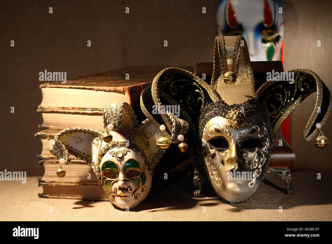 Art concept. Vintage still life with old books near masks Stock Photo ...