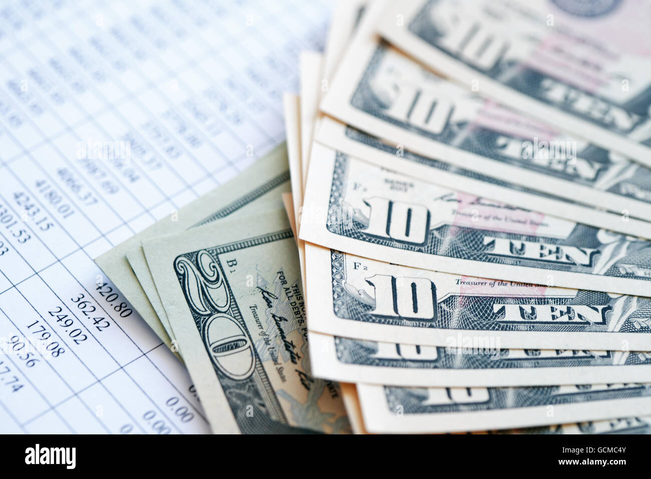 Bookkeeping concept. Closeup of dollar bank notes on paper list with ...
