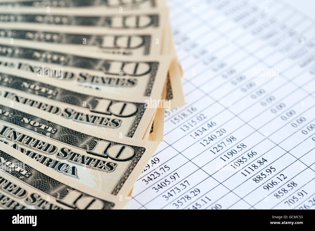 Bookkeeping concept. Closeup of dollar bank notes on paper list with ...