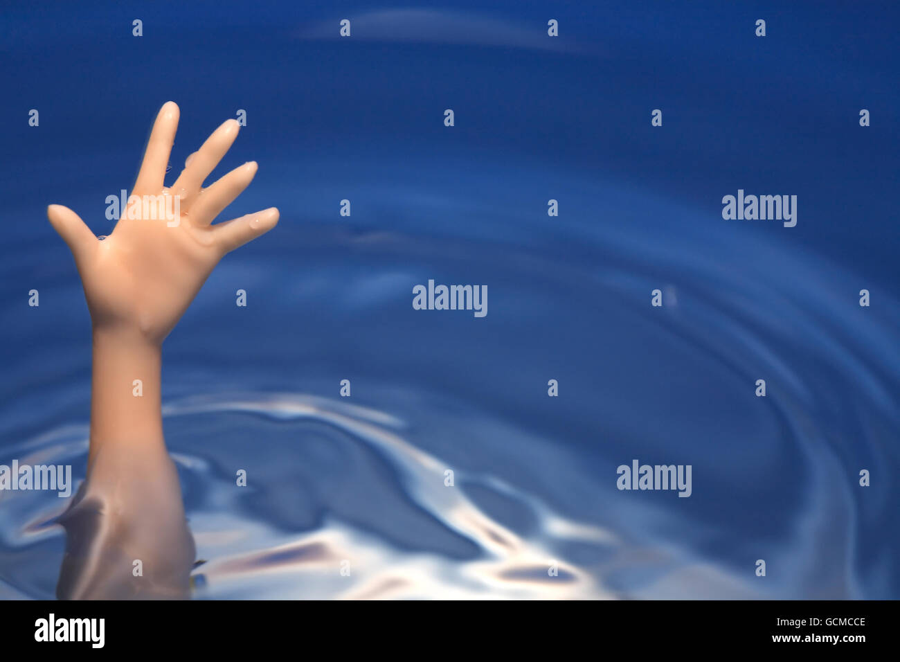 SOS concept. Plastic hand in blue waving water Stock Photo - Alamy