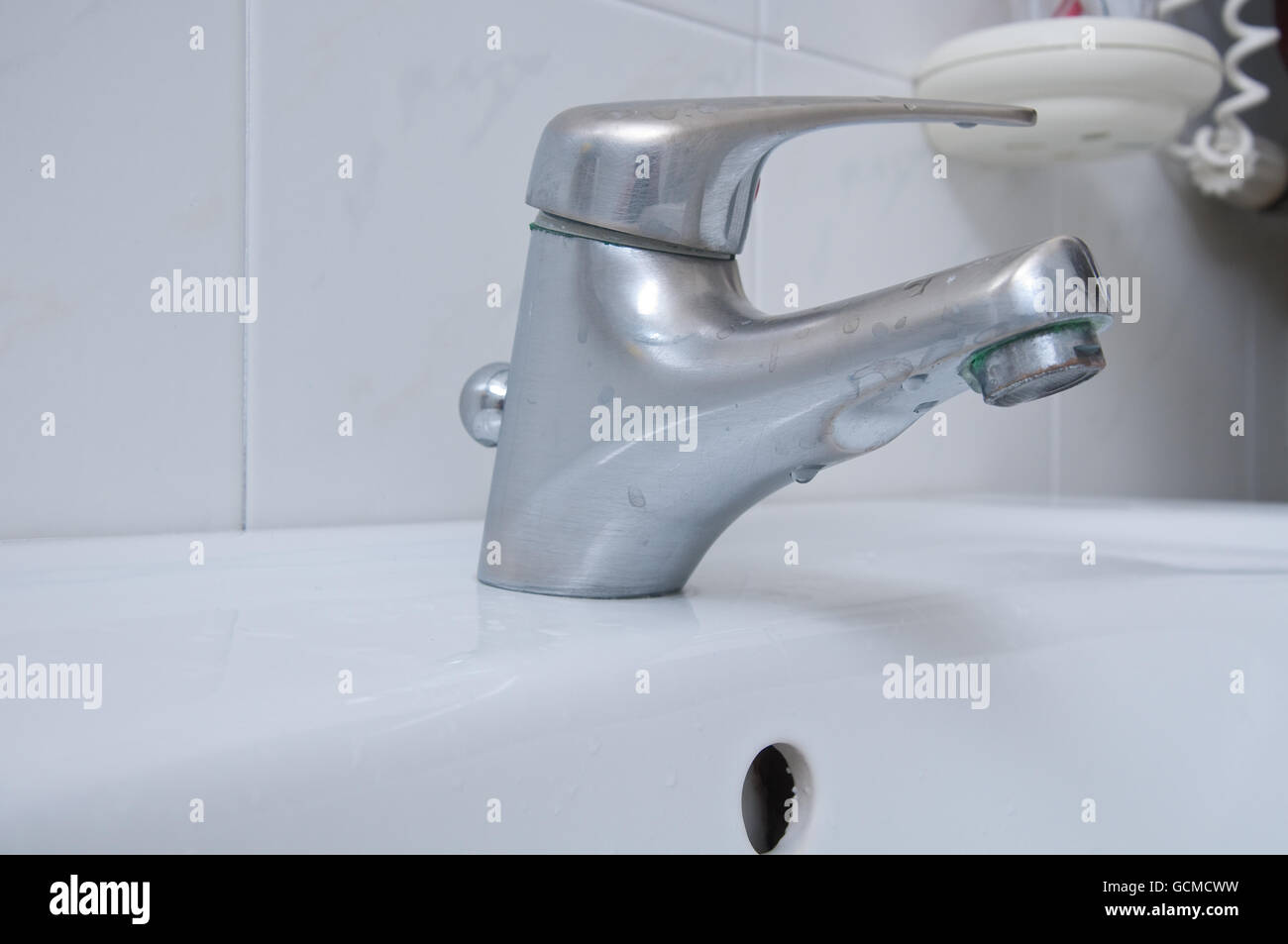 gray faucet on a white sink Stock Photo - Alamy