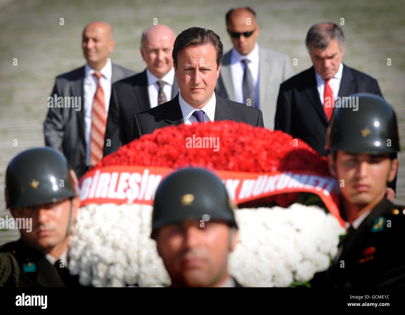Prime Minister David Cameron carries a wreath along The Lion's Walk at ...