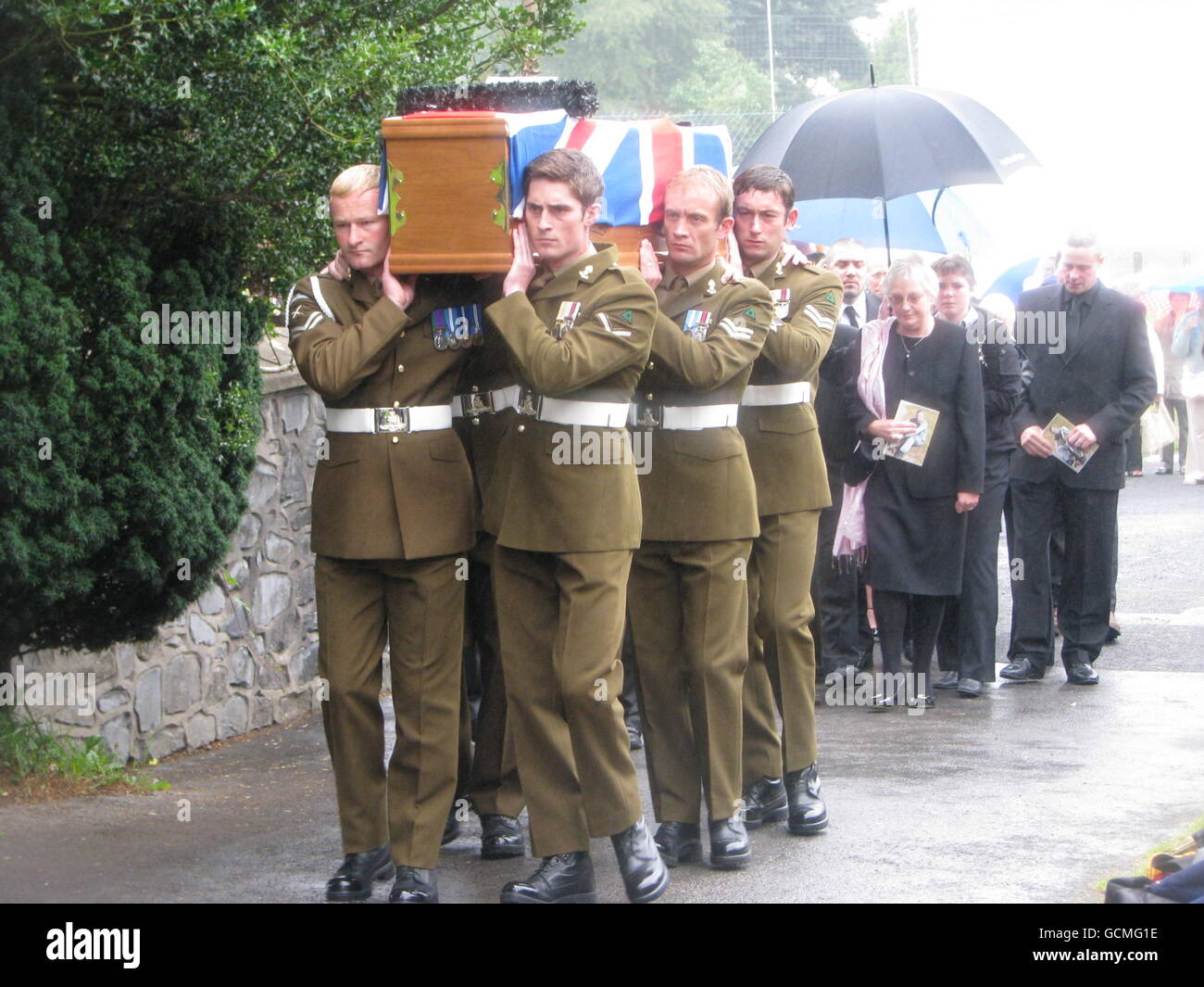 The coffin of Bombardier Samuel Robinson is carried into St Mary's ...