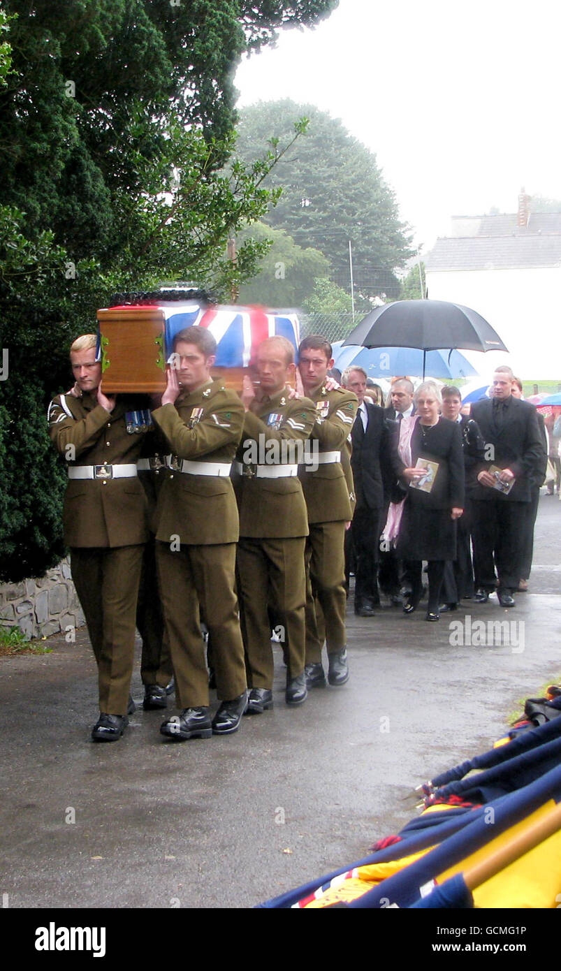 The coffin of Bombardier Samuel Robinson is carried into St Mary's ...