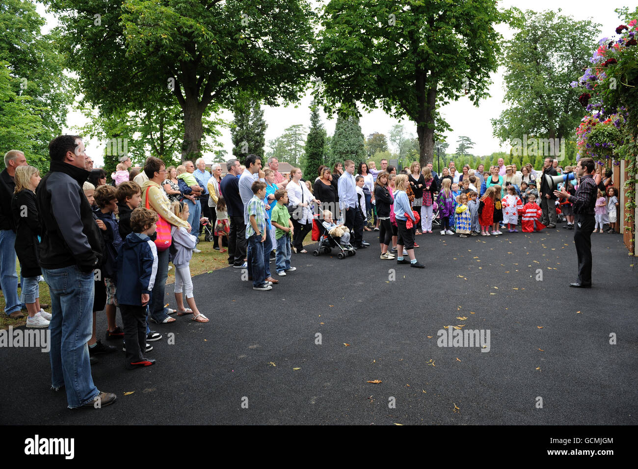 Children and Adults queue up as they wait to enter Lingfield Racecourse ...