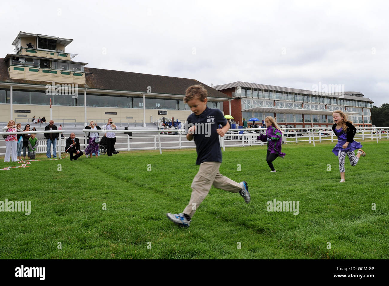 Children take the opportunity to run along the course at Lingfield ...