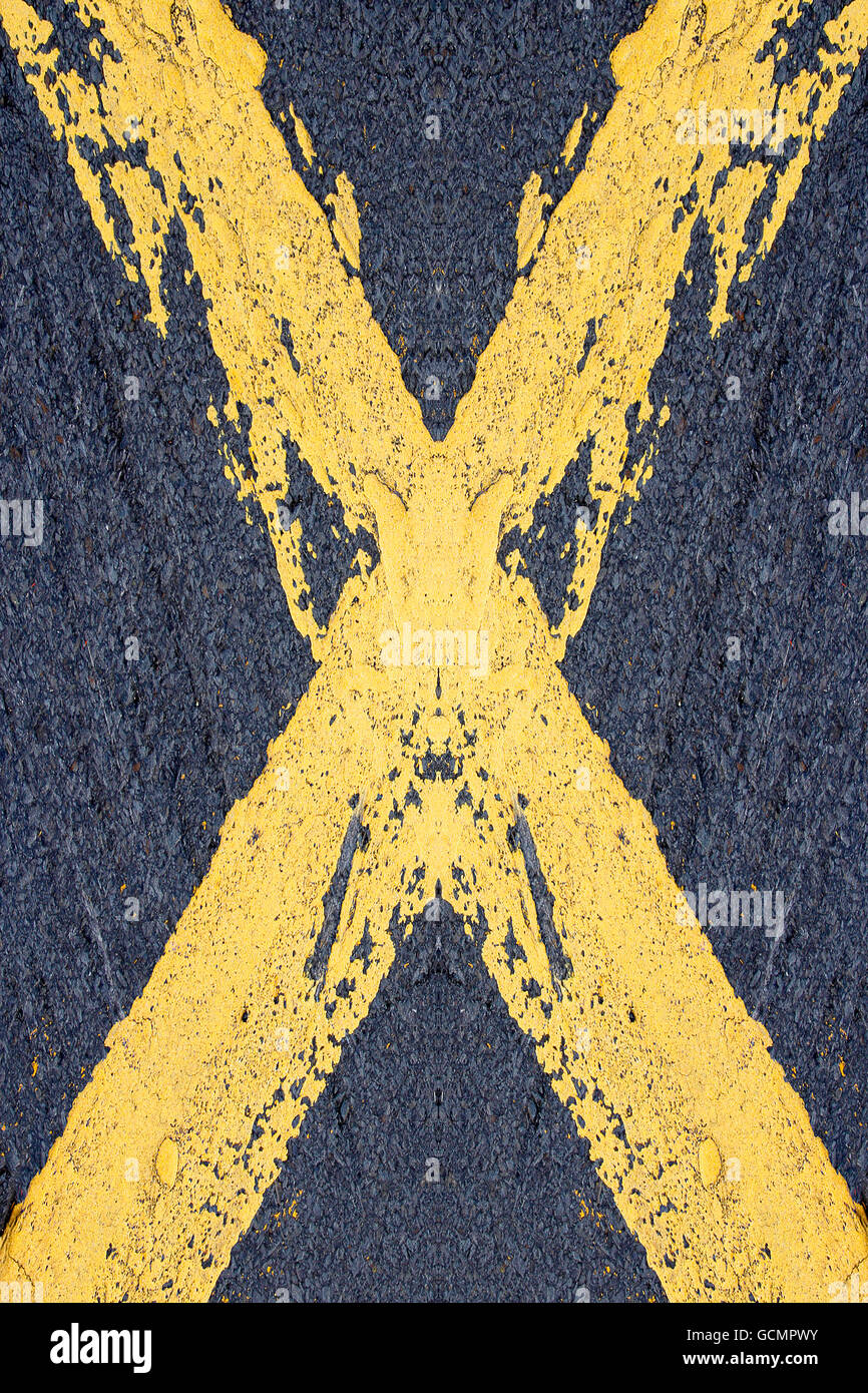 Painted yellow cross on a road pattern Stock Photo - Alamy