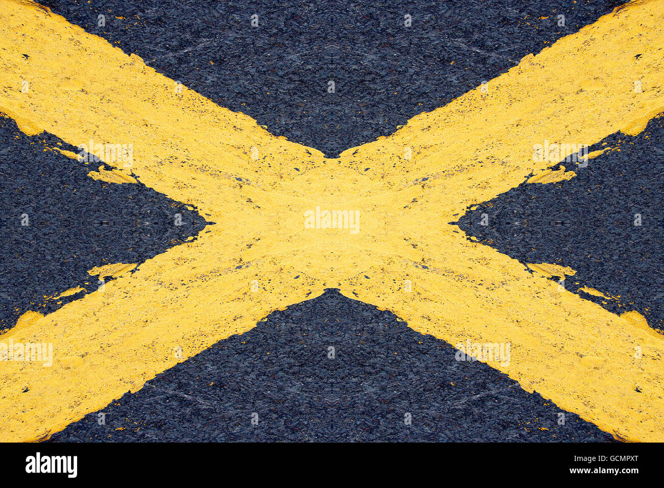 Painted yellow cross on a road pattern Stock Photo - Alamy