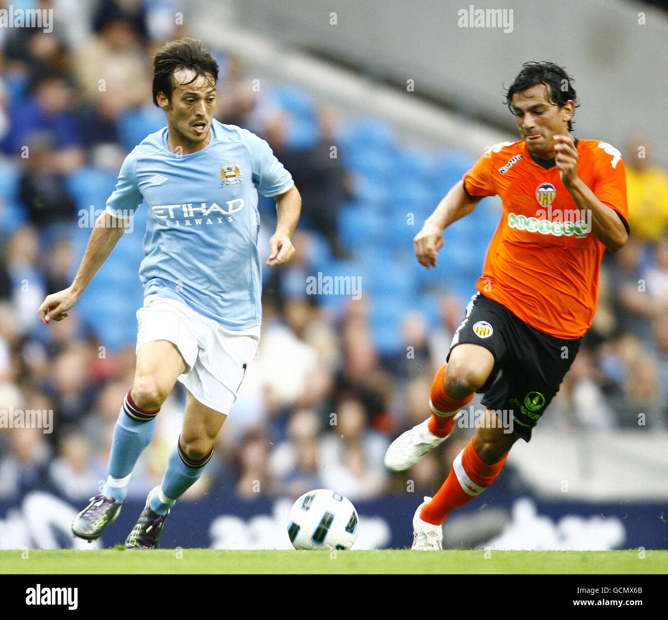 Manchester citys david silva and valencias mehmet topal hi-res stock ...
