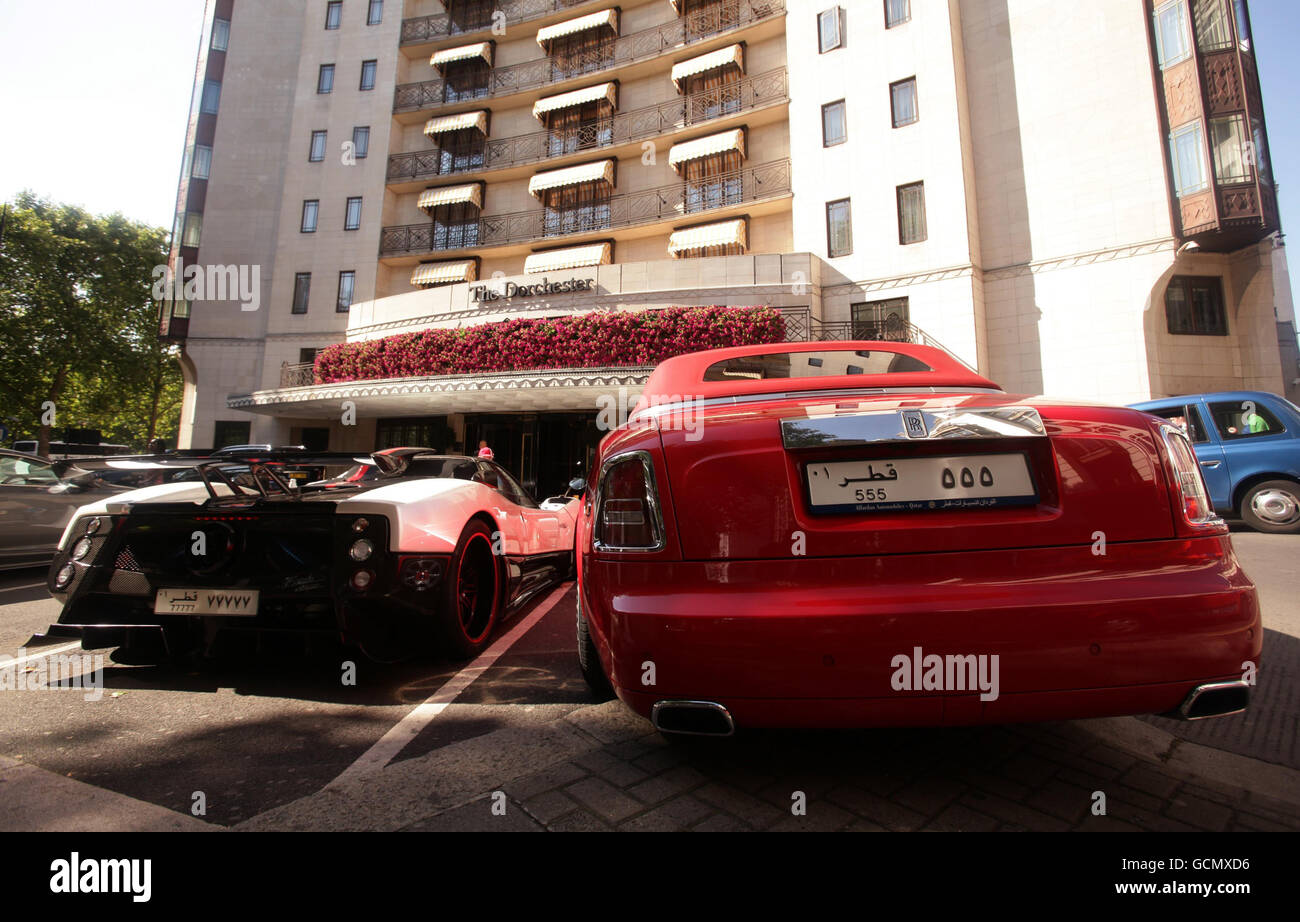 A Pagani Zonda sports car (left) and a Rolls Royce, both displaying ...
