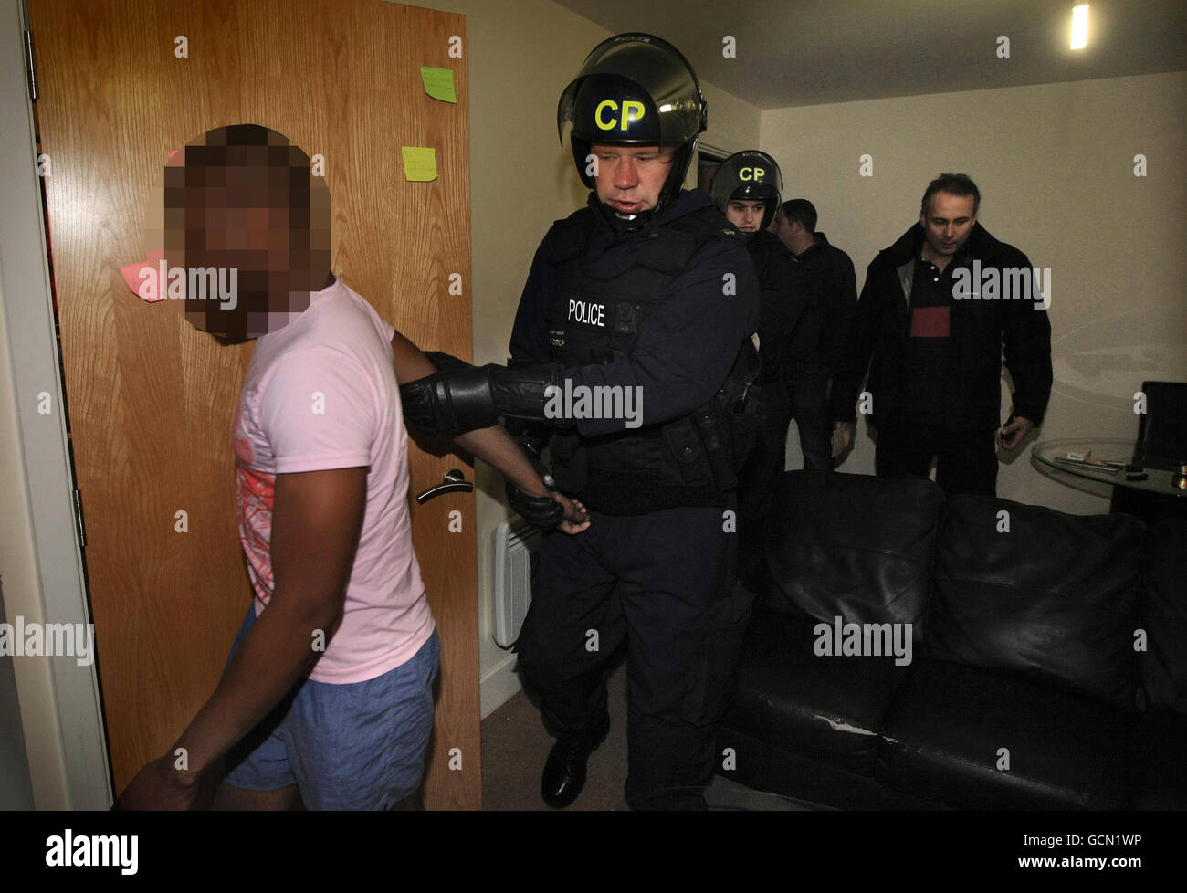 EDS NOTE: FACE PIXELATED BY PA PICTURE DESK. Police raid an address in ...