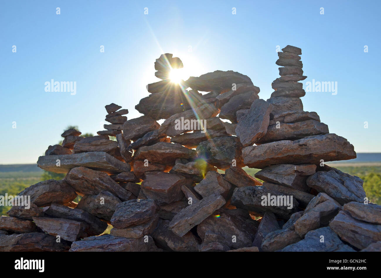 Sun flare through rock cairns in outback Queensland, Australia Stock ...