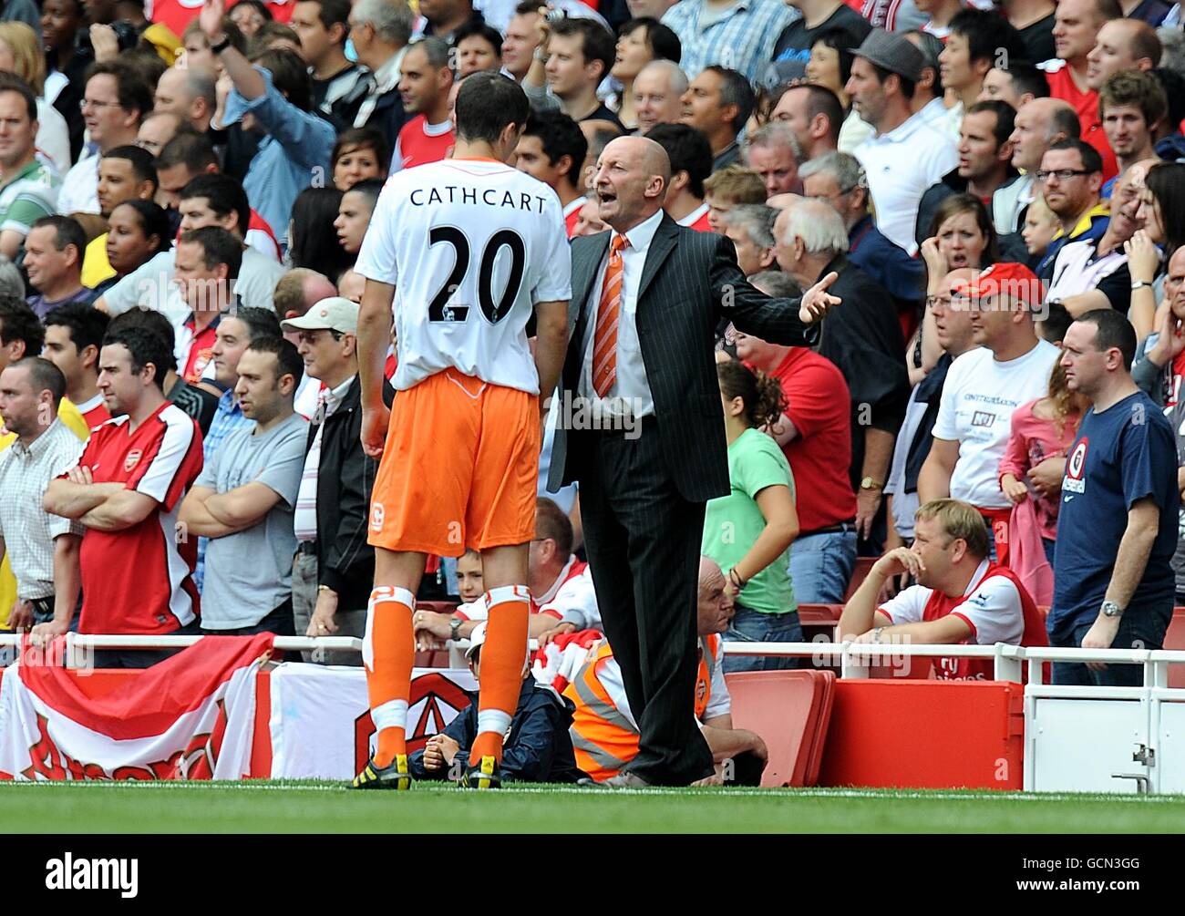 Blackpool manager Ian Holloway talks with Craig Cathcart as he tries to ...