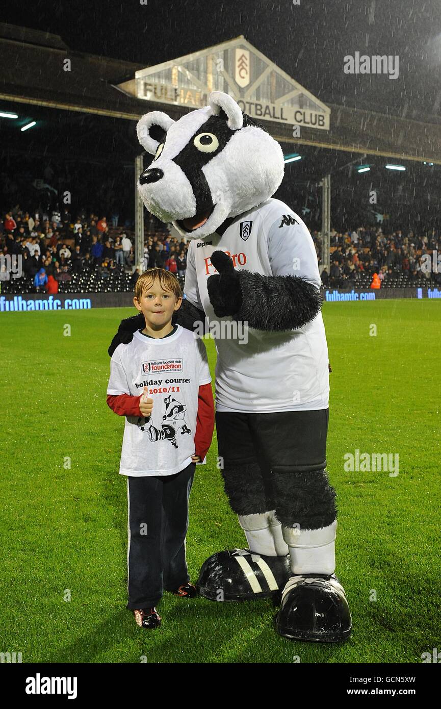 A competition winner poses with Fulham mascot Billy the Badger at half ...