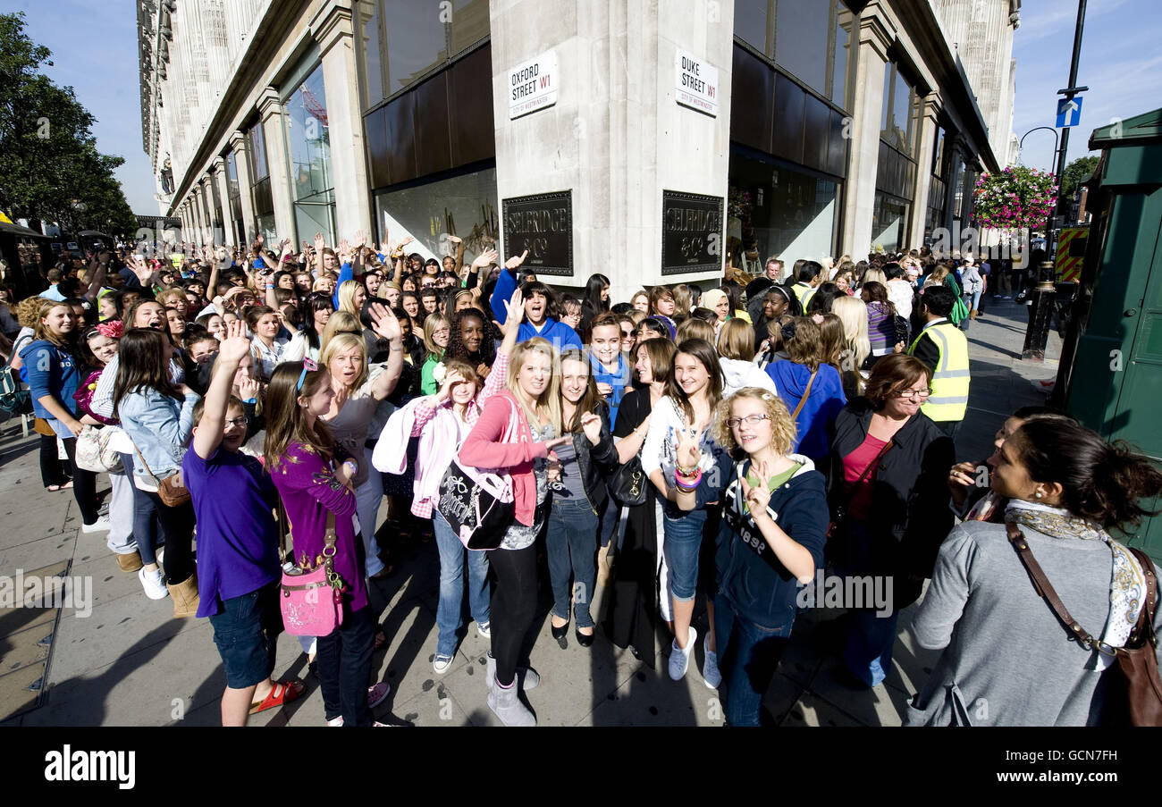 The queue of girls stretches round the block as they wait to meet JLS ...