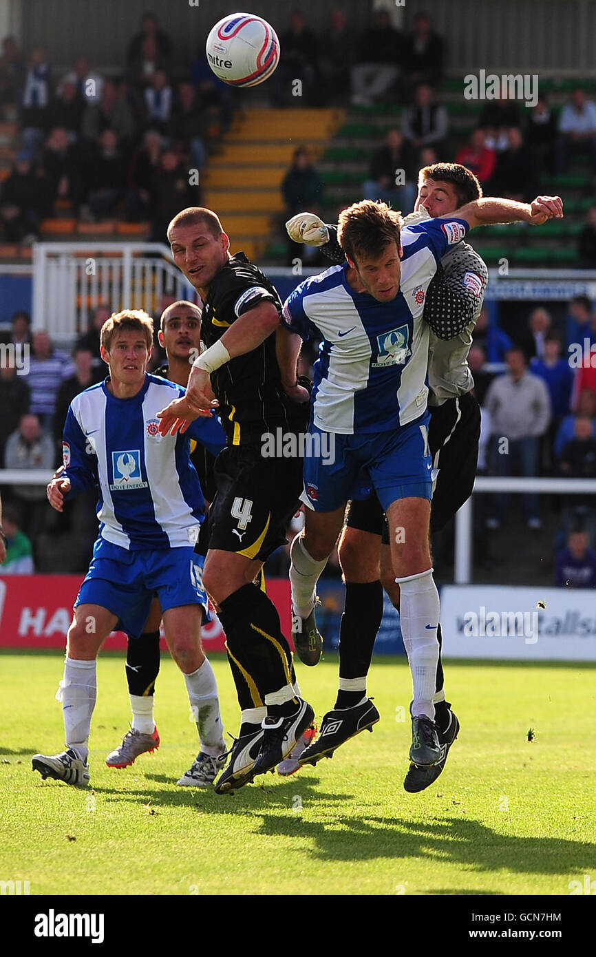 Hartlepool United goalkeeper Scott Flinders (right) punches the ball ...
