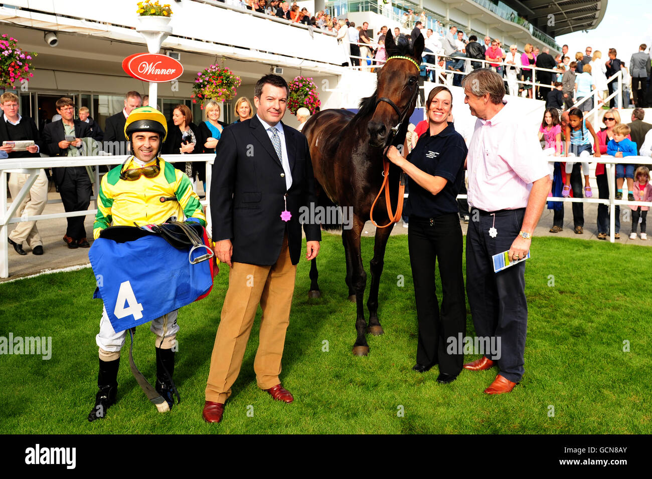 Jockey Alan Munro (far left) and trainer Chris Wall (far right ...