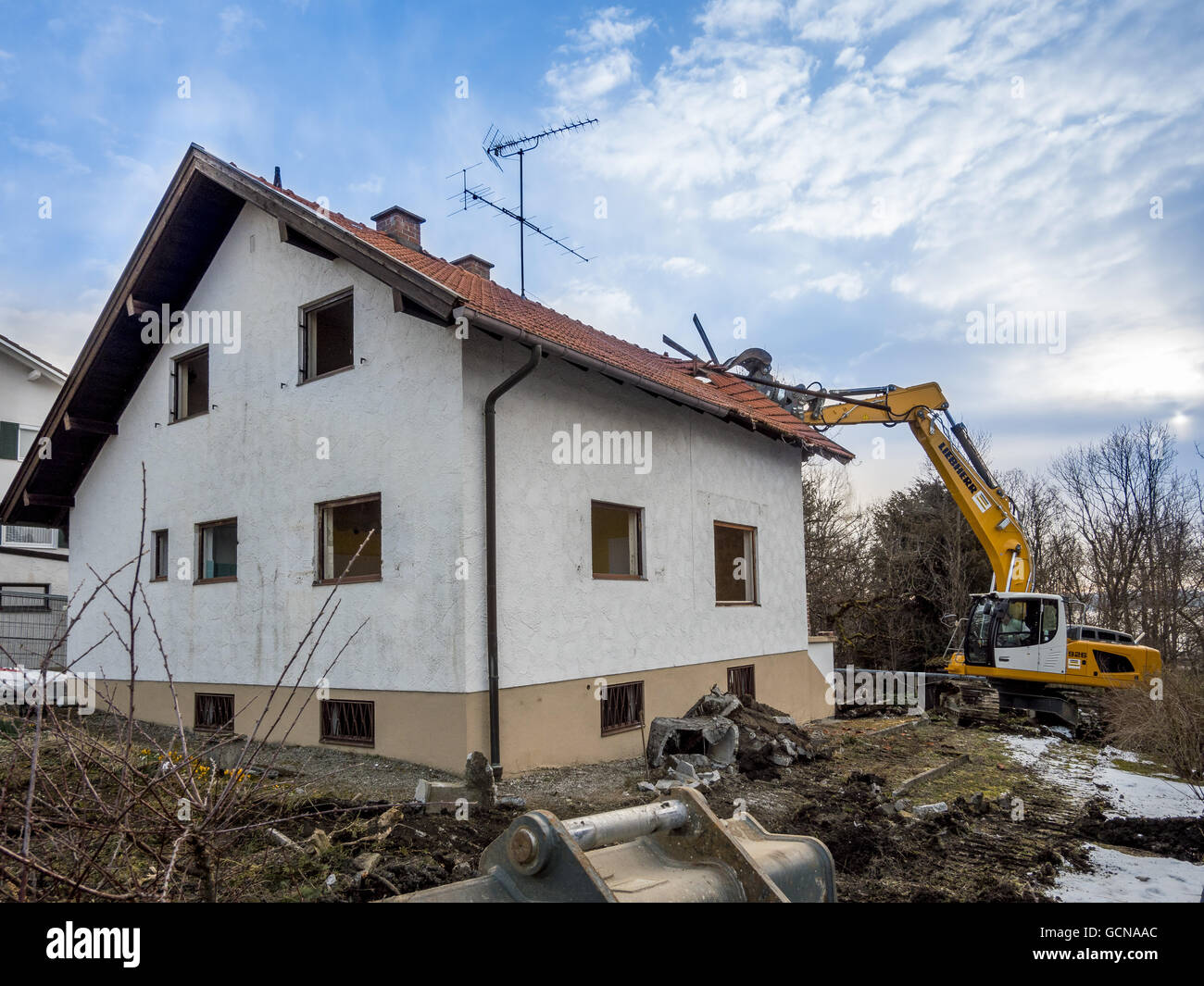 Excavator demolishing a house Stock Photo - Alamy