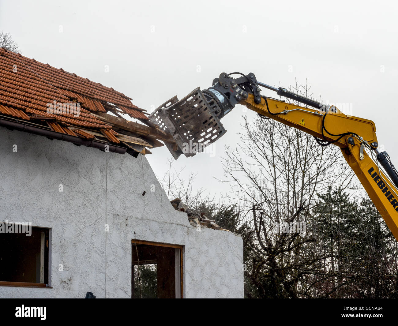 Excavator demolishing a house Stock Photo - Alamy