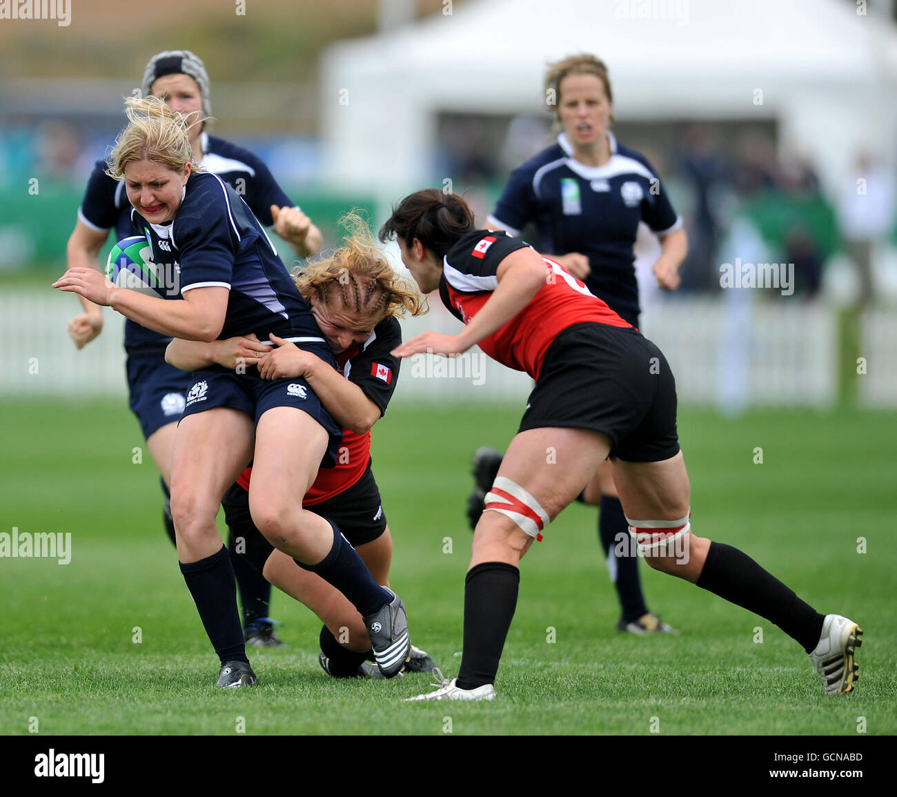 Scotland's Suzi Newton (left) is tackled by Canada's Kim Donaldson ...