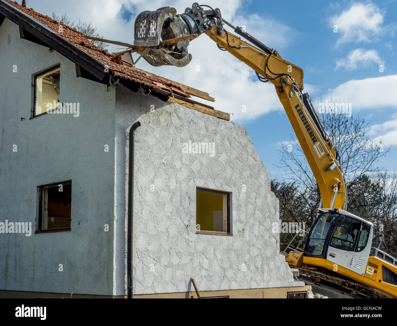 Excavator demolishing a house Stock Photo - Alamy
