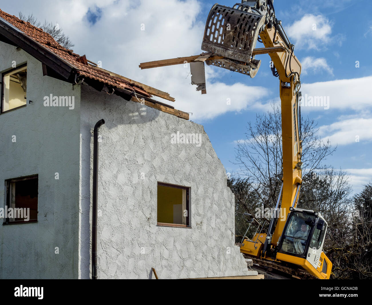 Excavator demolishing a house Stock Photo - Alamy