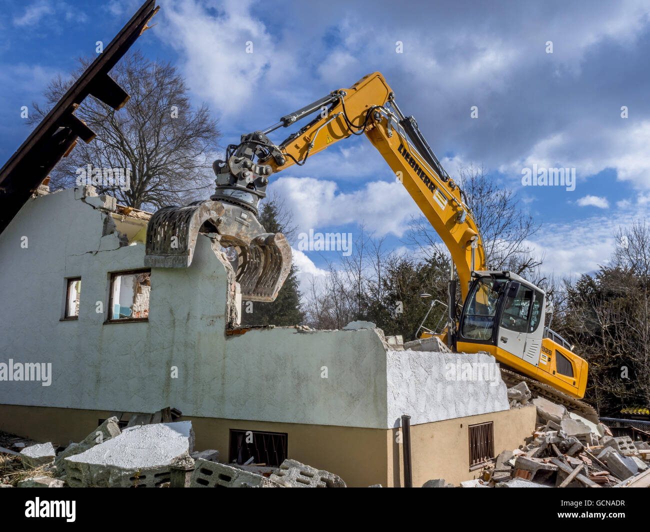 Excavator demolishing a house Stock Photo - Alamy