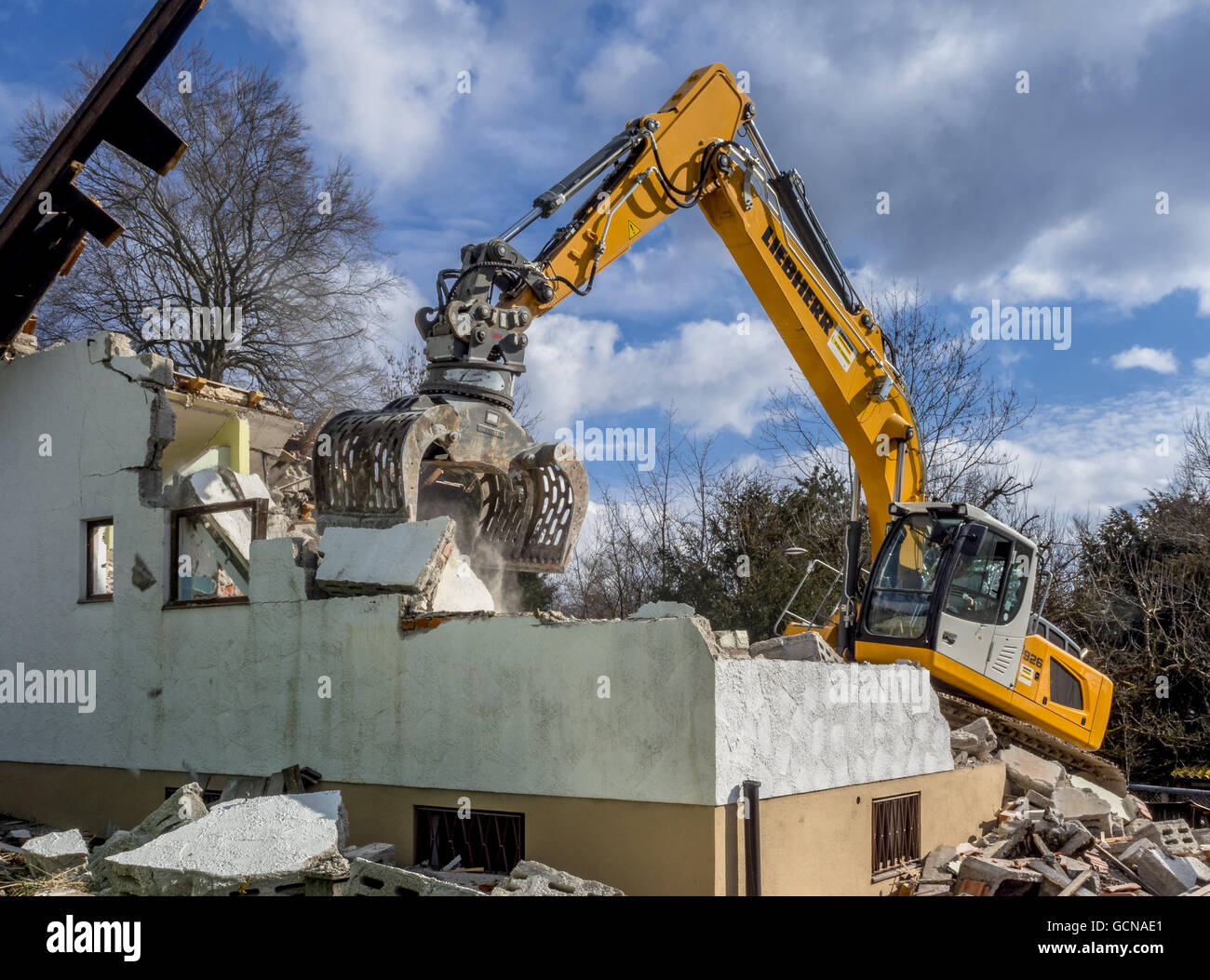 Excavator demolishing a house Stock Photo - Alamy