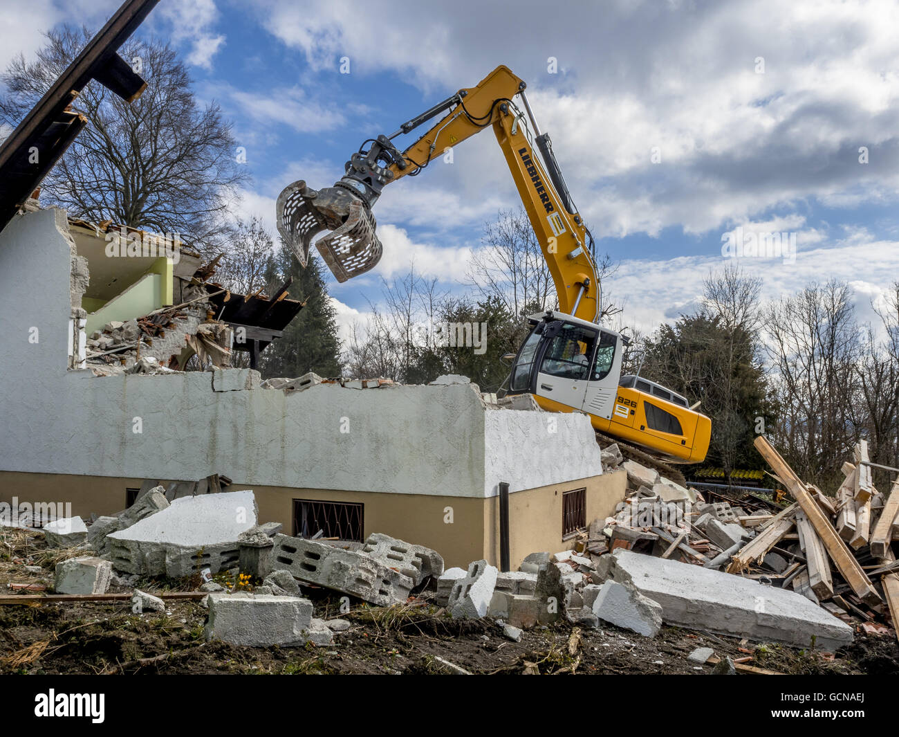 Excavator demolishing a house Stock Photo - Alamy