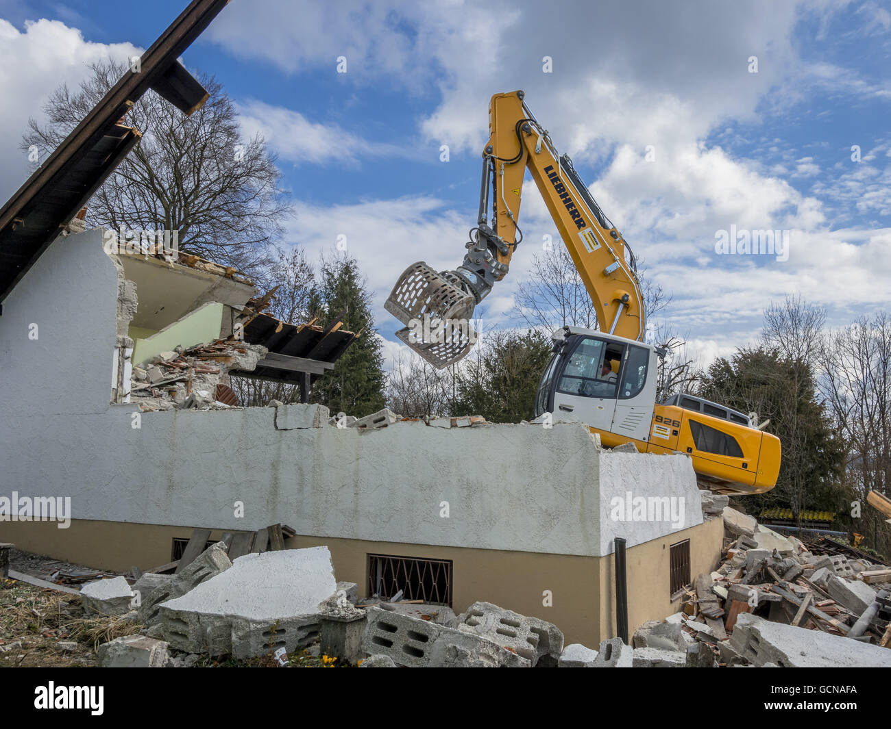 Excavator demolishing a house Stock Photo - Alamy