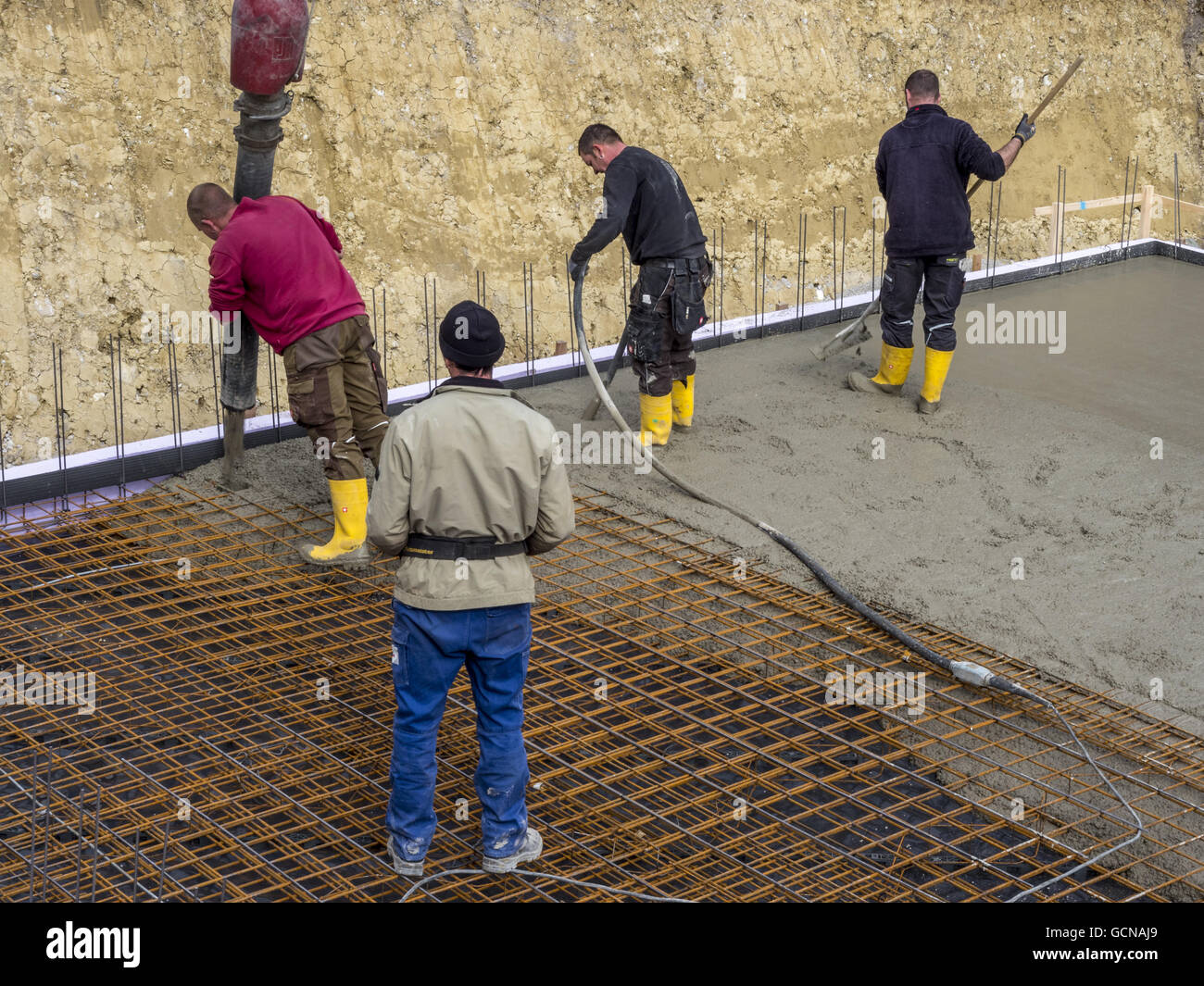 Construction worker when concreting a foundation base slab construction ...