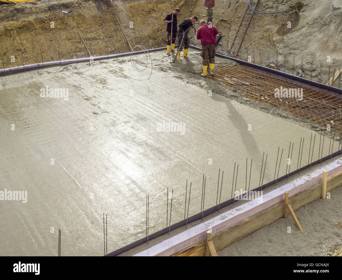 Construction worker when concreting a foundation base slab construction ...