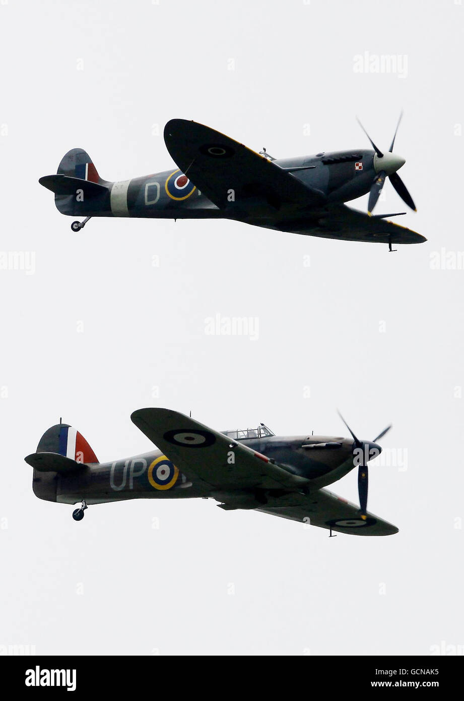 A Mk VB Spitfire (top) and a Mk 1 Hurricane fly past Biggin Hill ...
