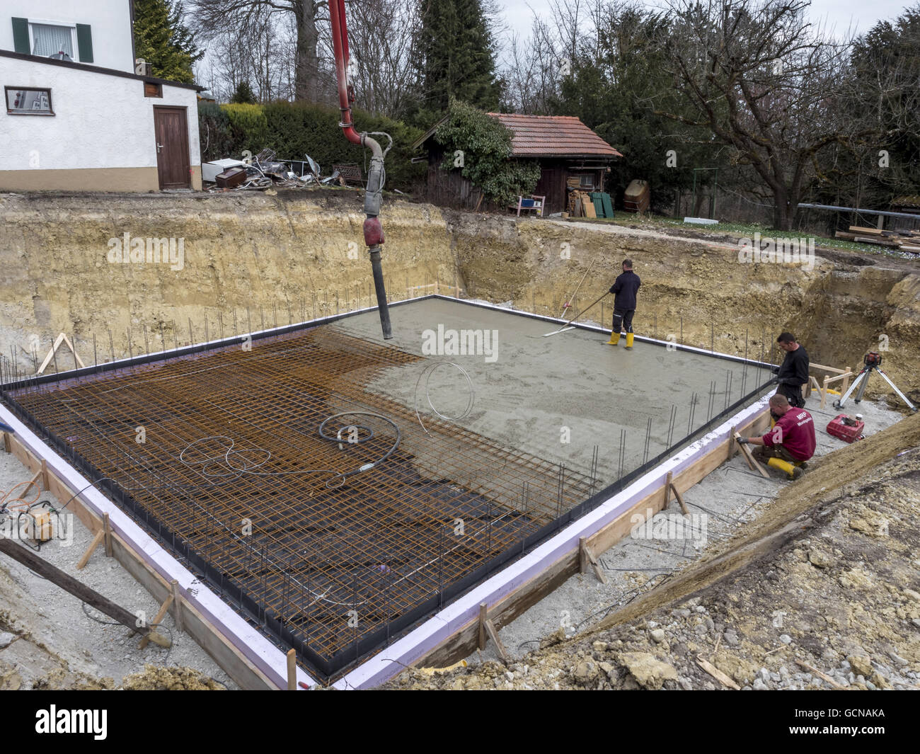 Construction worker when concreting a foundation base slab construction ...