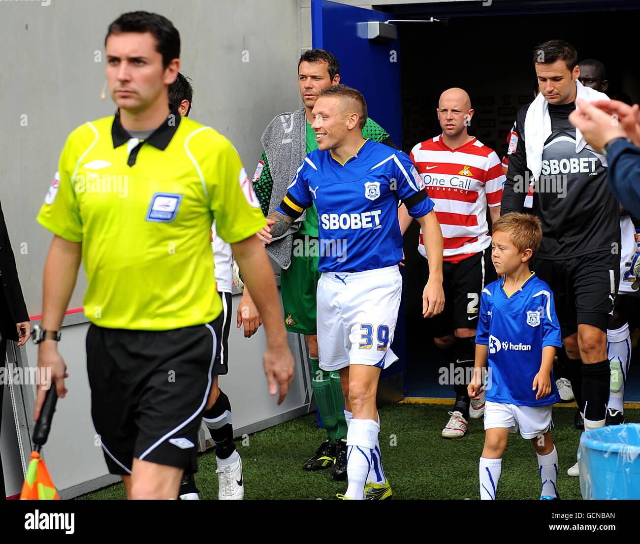 Cardiff City's captain Craig Bellamy is all smiles as he leads his side ...