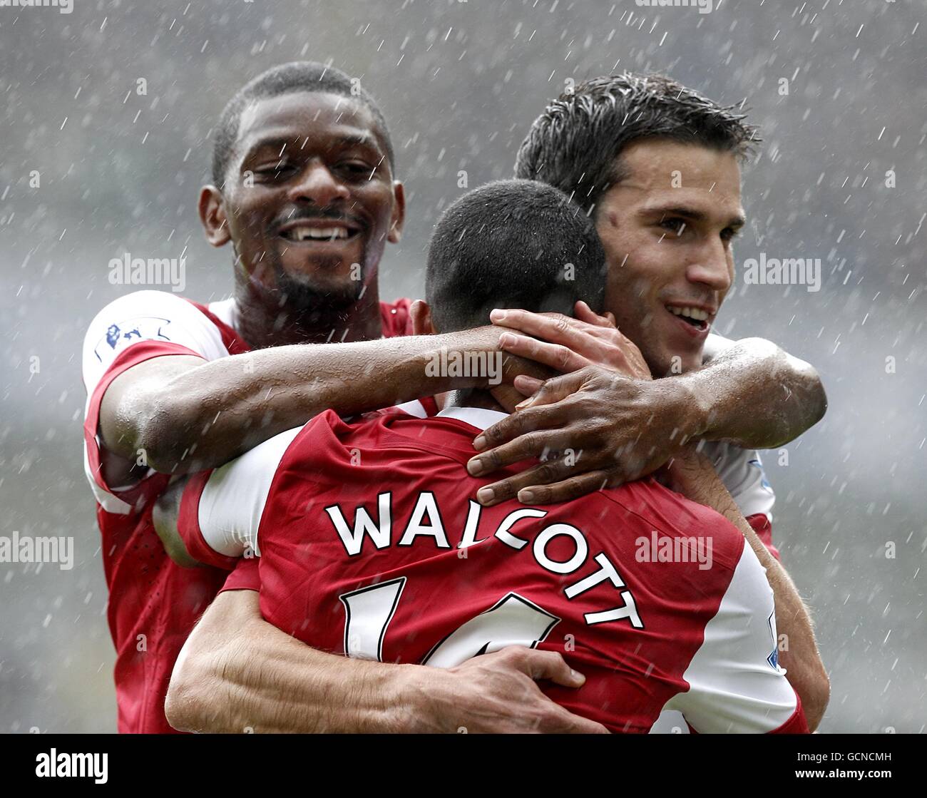 Arsenal's Theo Walcott (centre) celebrates scoring their first goal of ...