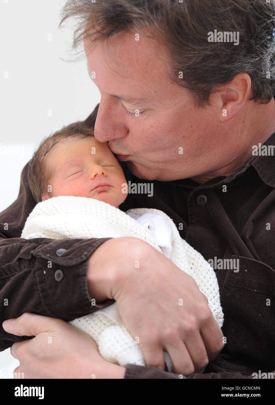 Prime Minister David Cameron holds his baby daughter, Florence Rose ...