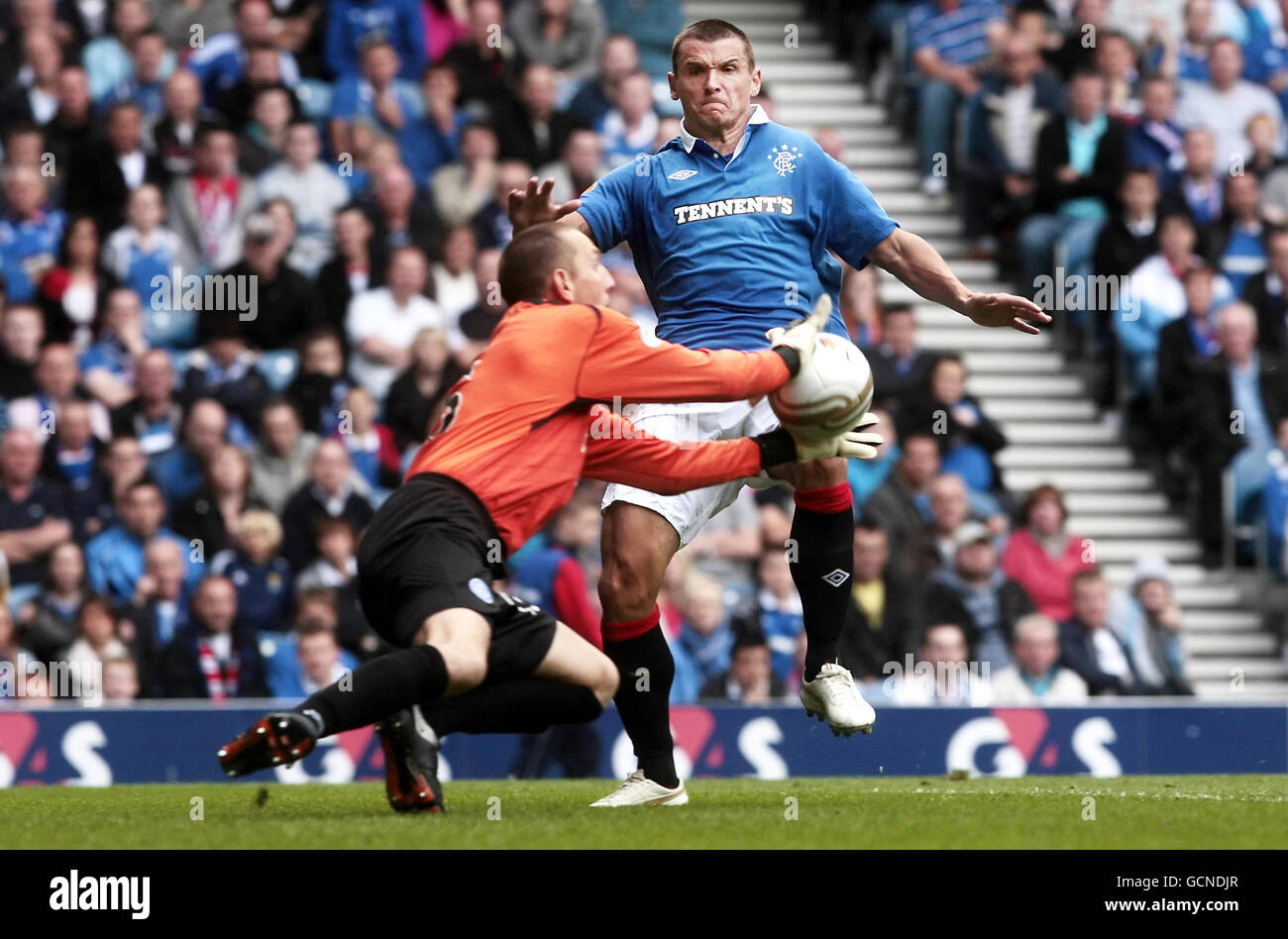 Rangers' Lee McCulloch (right) is beat to the ball by St Johnstone's ...