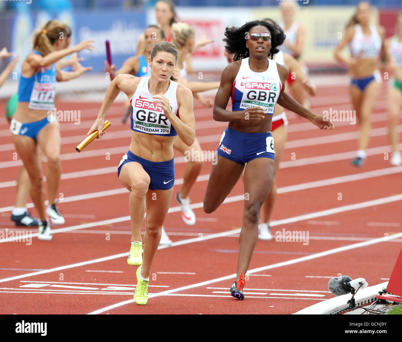 Graet Britain's Kelly Massey (left) receives the batton from team-mate ...