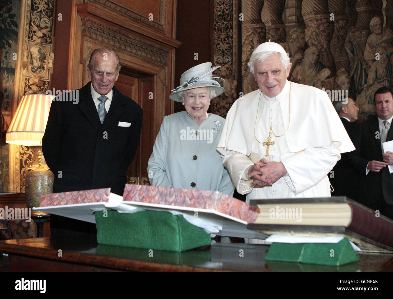 The Duke of Edinburgh looks on (left) as Queen Elizabeth II talks with Pope Benedict XVI ...