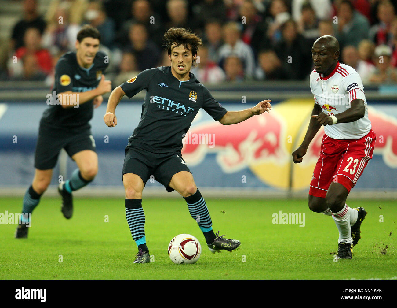 Manchester City's David Silva (centre) passes under pressure from Red ...
