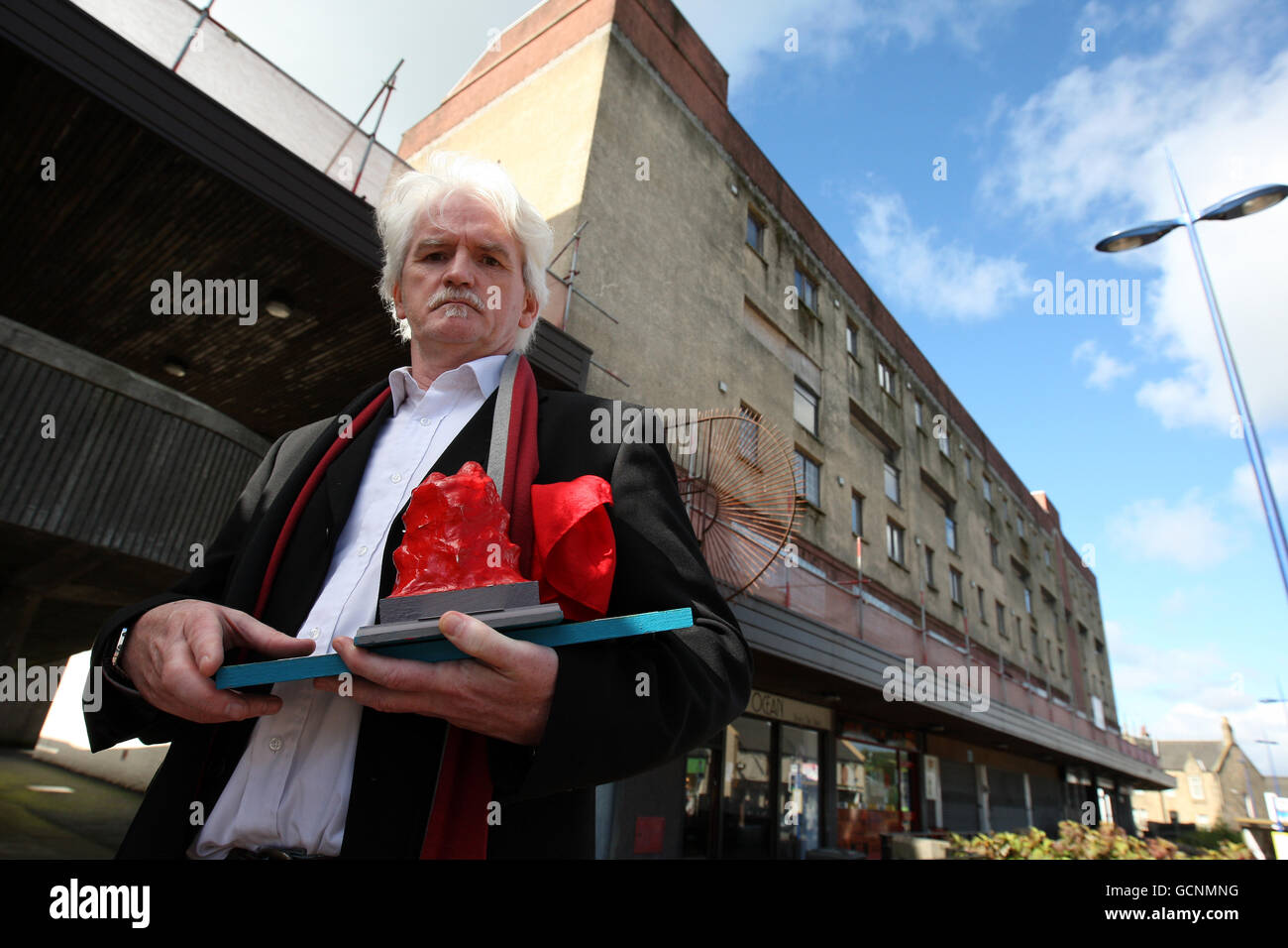Denny resident Brian McCabe holds the Carbuncle Award after residents ...