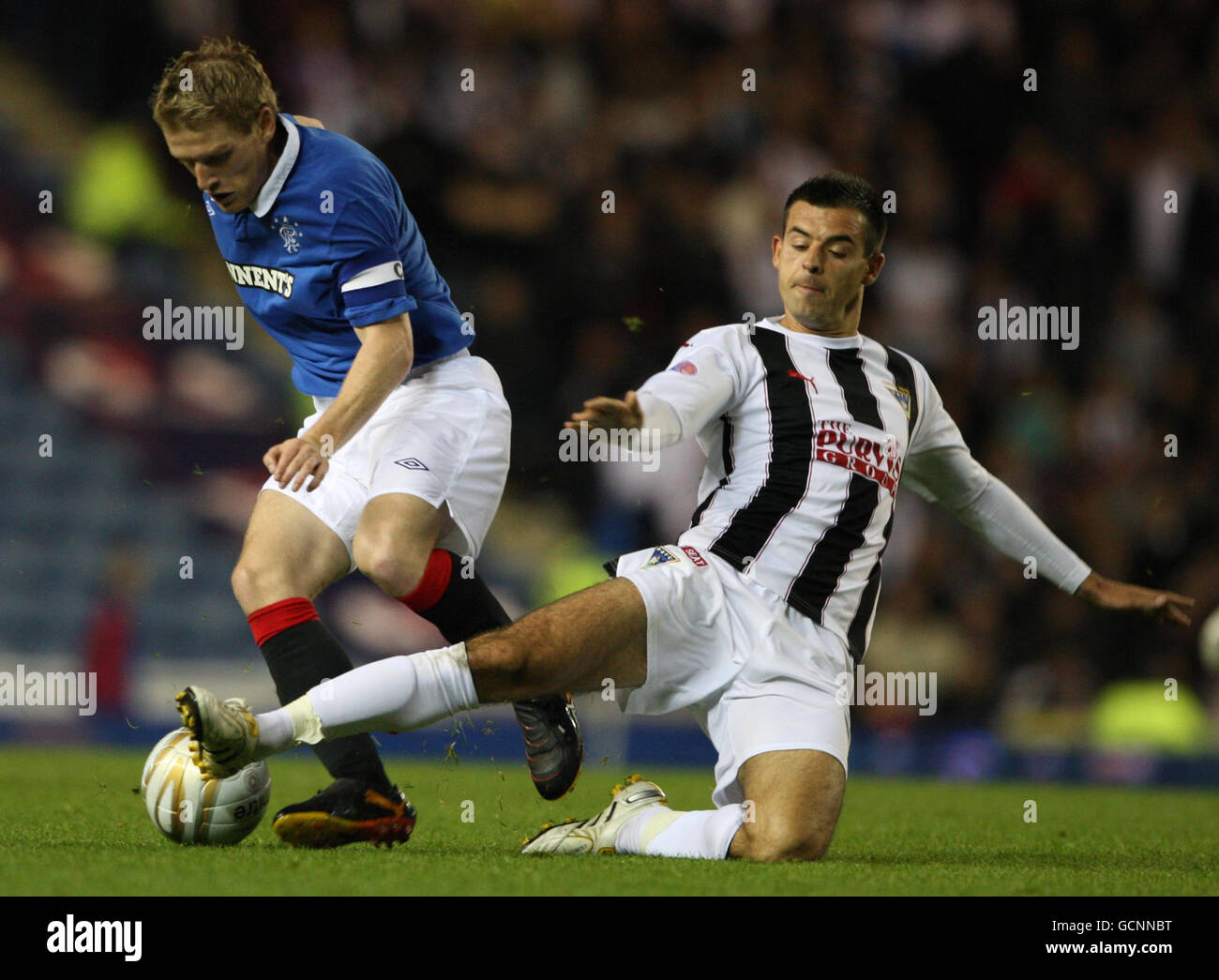 Rangers' Steven Davis (left) challenges Dunfermline's Steven Bell during the third round ...