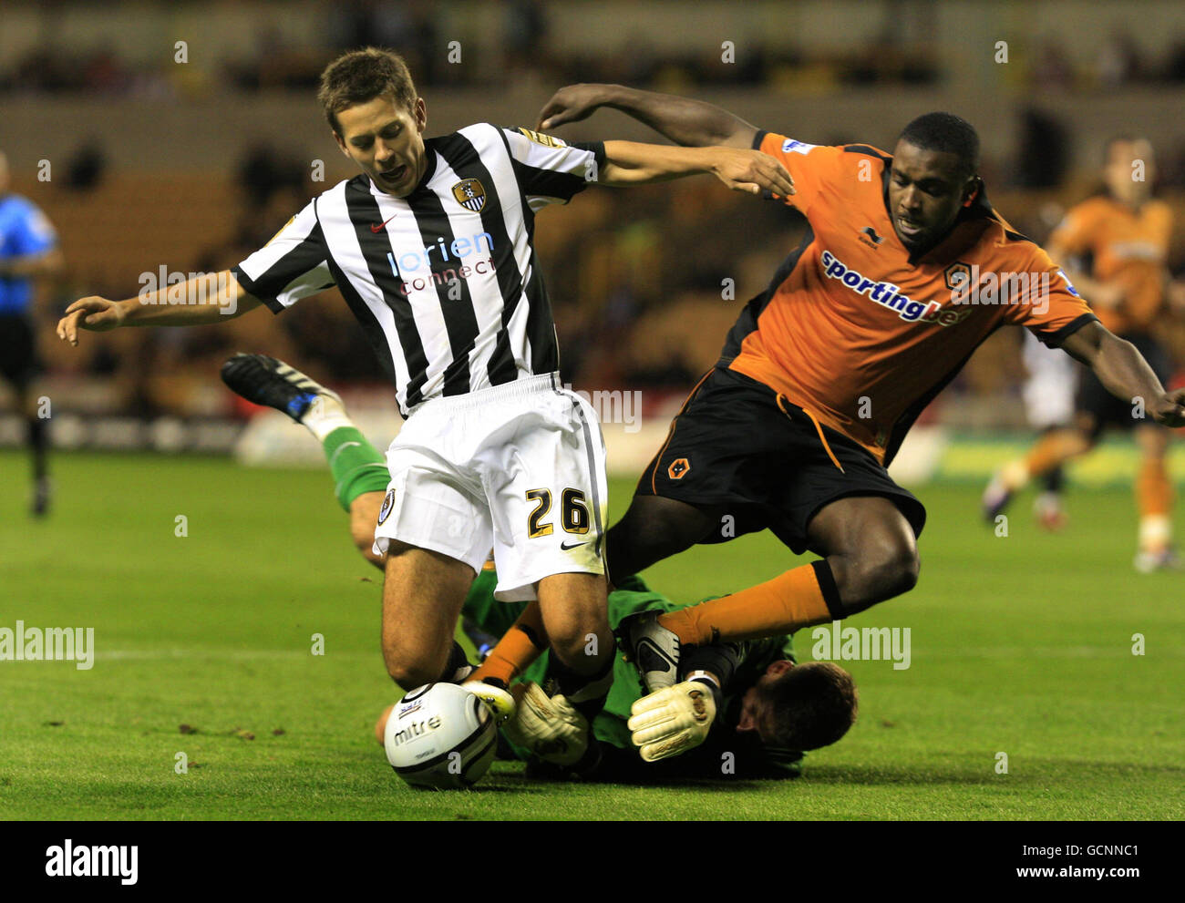 Notts County's Jon Harley and goalkeeper Rob Burch crowd out ...